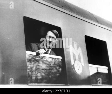 Adolf Hitler looks out the window of a train railway carriage during a ...