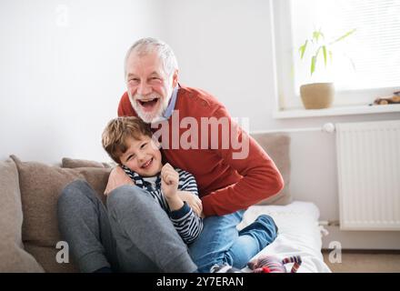 Grandfather spending time with grandson, taking care of him while ...