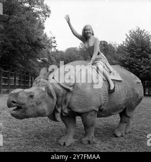 Michaela Denis rides a rhino at Whipsnade Zoo. She and her husband ...