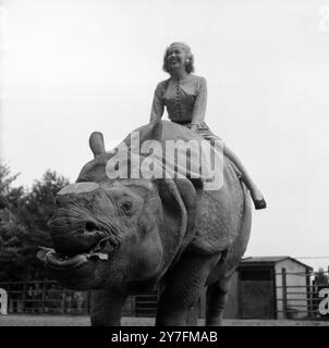 Michaela Denis rides a rhino at Whipsnade Zoo. She and her husband ...