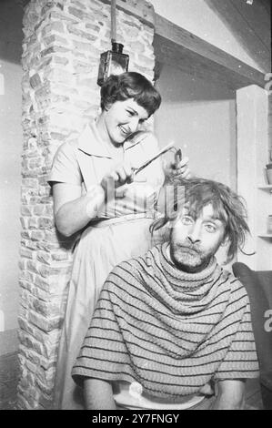 Spike Milligan gets a haircut, at home in north London with his first ...