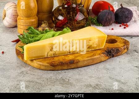 Hard parmesan cheese triangle over board served salad Stock Photo - Alamy