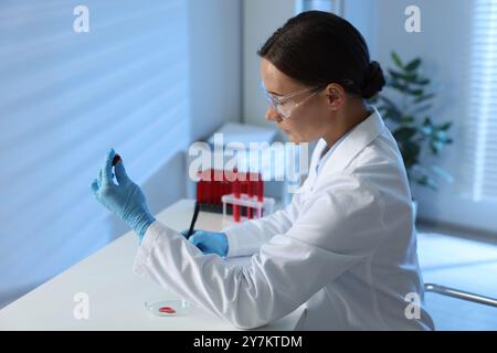 Laboratory testing. Doctor taking notes at table indoors Stock Photo ...