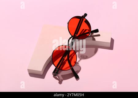 Decorative podium with stylish sunglasses on orange background Stock ...
