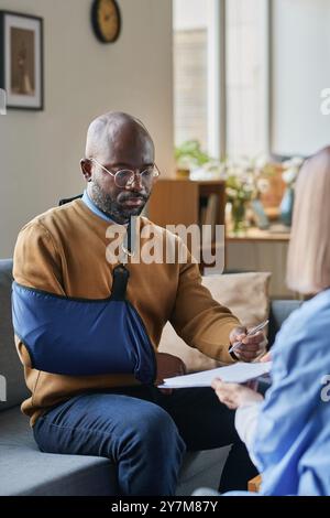 Black Man with Broken Arm Signing Medical Form Stock Photo - Alamy