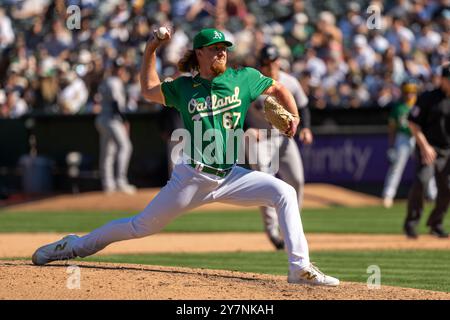 Athletics pitcher Grant Holman throws a pitch to the Texas Rangers ...