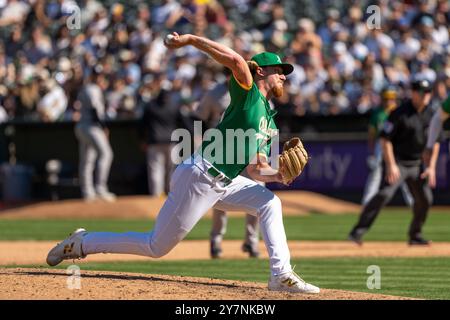 Athletics pitcher Grant Holman throws a pitch to the Texas Rangers ...