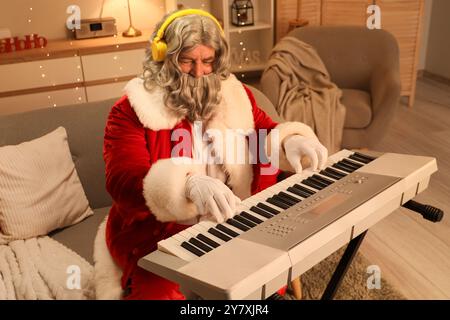 Santa Claus playing synthesizer at home on Christmas eve Stock Photo ...