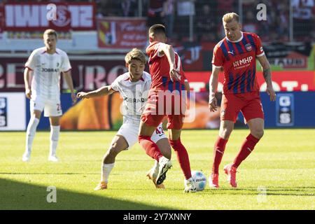 Freiburg players Ritsu Doan, left, and Lukas Kübler, centre, fight for ...