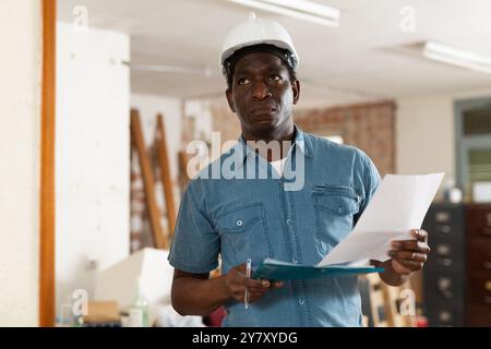 Responsible engineer with papers conducting inspection of construction ...