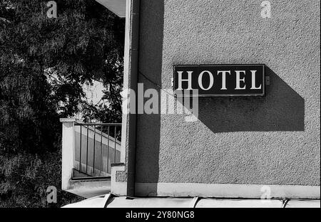 Hotel Sign and Balcony Fence: A Play of Light, Shadow, and Typography ...