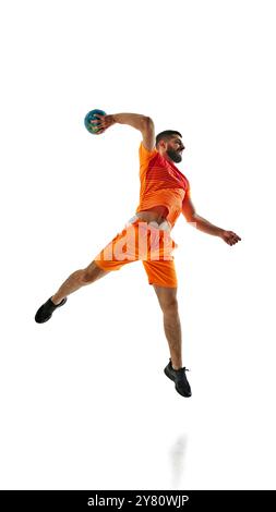 Powerful determined man, handball athlete in orange uniform in motion ...
