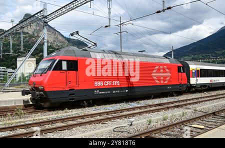 SBB passenger train with a red Re 460 locomotive leaves the 57 km long ...