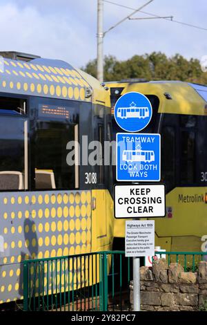 Blue and white tram warning signs at tramway with bee network metrolink ...