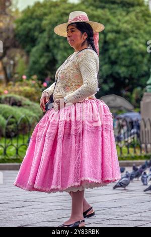 Native indigenous Bolivian woman with braids in traditional dress ...
