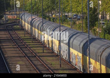 Colourfully painted goods train with freight wagons from a bird's eye ...