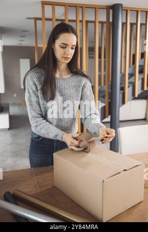 Young caucasian woman getting parcel from cell of automatic post ...