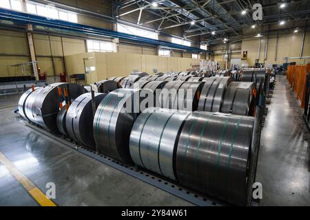 Rolls of perforated galvanized steel sheet in metalworking factory ...