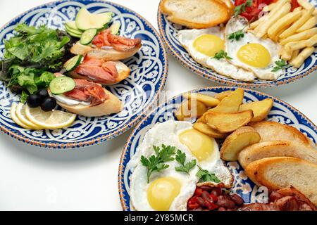 Traditional breakfast plates featuring eggs, sausages, and various ...