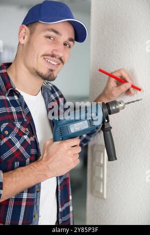 workman or builder marking a spot with pencil Stock Photo - Alamy