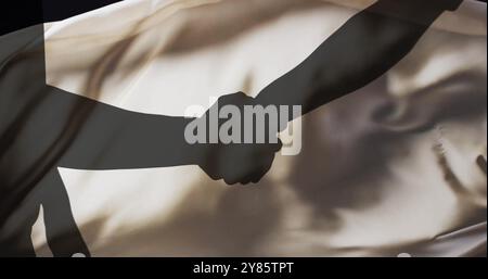 Image of silhouettes of people and floating cloth on black background ...
