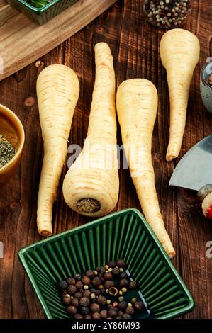 Uncooked useful whole parsnips roots on the kitchen table. Top view ...