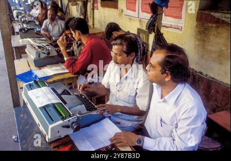 Bangladesh, Dhaka, writers with typewriters fill out forms and/or write ...