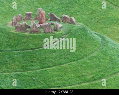 Huge boulders atop one of the mounds with a spiralling path ...
