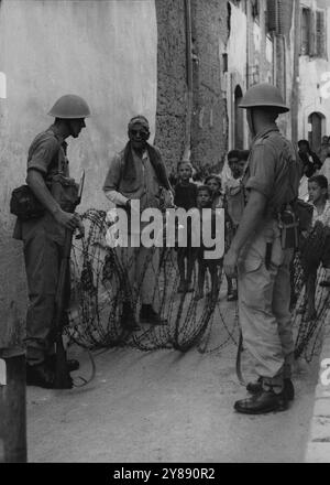 Precautions Again In Nicosia -- A Turk haggling with the guards at a ...