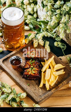 Beer with roasted ribs and French fries, perfect meal for a traditional ...