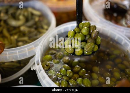 Heap of green olives with pits in buckets Stock Photo - Alamy