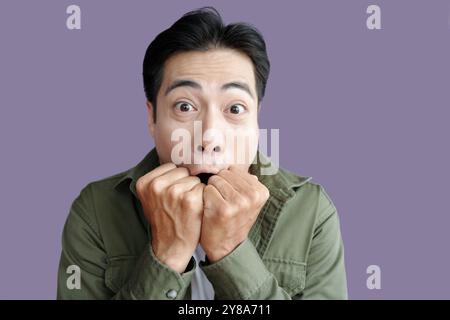Portrait of shocked young man in bathrobe on pink background Stock ...