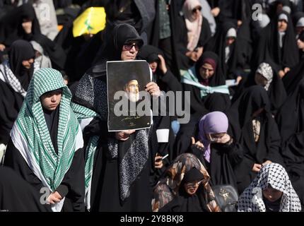 A woman holds a poster of the Iranian Supreme Leader Ayatollah Mojtaba ...