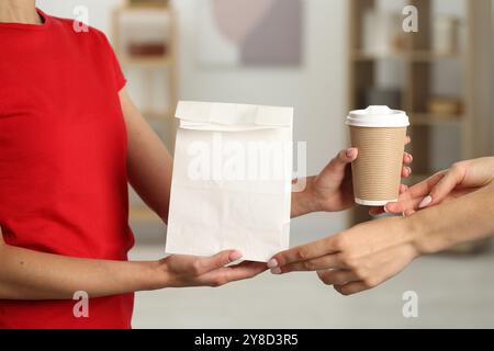 cashier giving takeaway drink to woman in medical mask in car, banner ...