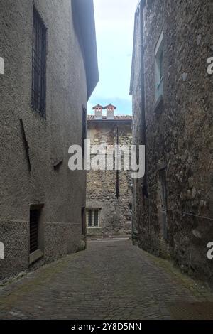 Dead end narrow alley between buildings with stone walls in a town ...