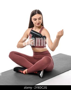 Young woman using percussive massage device at home Stock Photo - Alamy