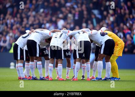 Liverpool have a team huddle during the Premier League match at Anfield ...