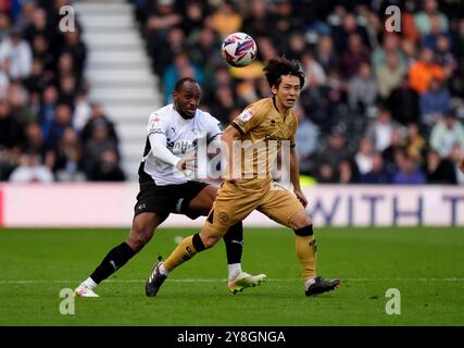 Derby County's Ryan Nyambe and Queens Park Rangers' Kenneth Paal (right ...