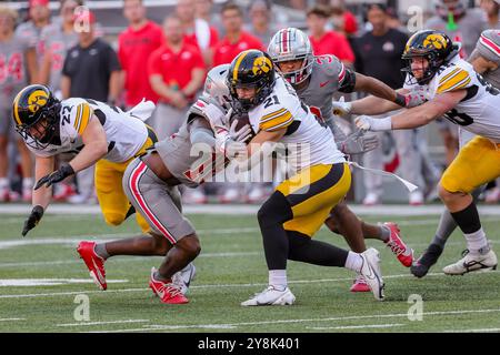Iowa wide receiver Kaden Wetjen (21) breaks a tackle by Rutgers ...