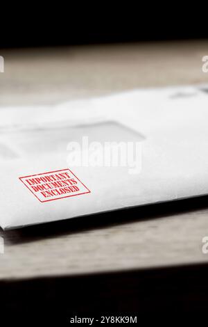 Important documents enclosed letter stamped in red on an envelope ...