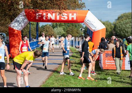 Runners cross the finishing line. The Bidwells Cambridge 10k is part of ...