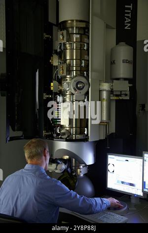 Nanomaterials research. Researcher using an advanced electron ...