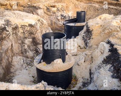 Modern plastic wells for underground communications Stock Photo - Alamy