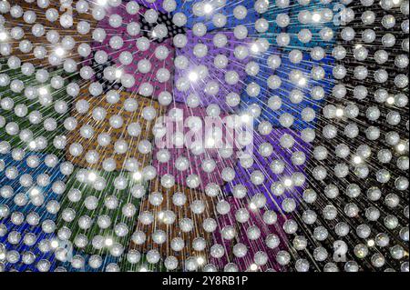 Abstract photograph of dozens of tiny, colorless, plastic balls set ...