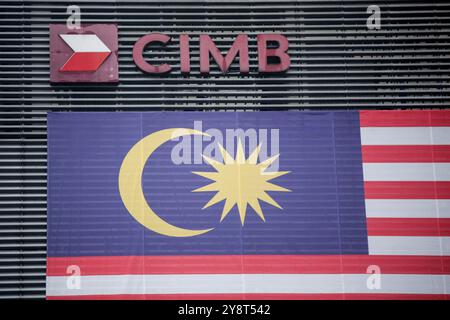 Cimb bank logo seen next to a Malaysia flag in Kuala Lumpur. Brand and ...