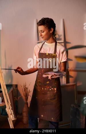 A young woman expresses her creativity by painting a vibrant picture at ...
