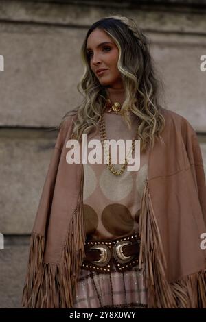 Cris Mata wearing turtle neck sweater, a plaid skirt, wrapped sweater ...