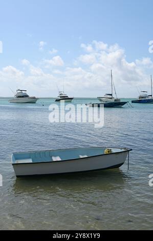 A beautiful shot of white sandy beach with seascape under blue sky ...