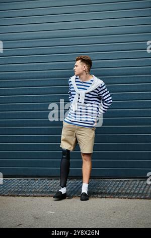 Tall handsome confident young man in a jacket sitting on the chair and ...