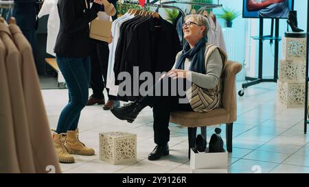 Elderly woman searching for a comfortable pair of shoes at mall, asking ...